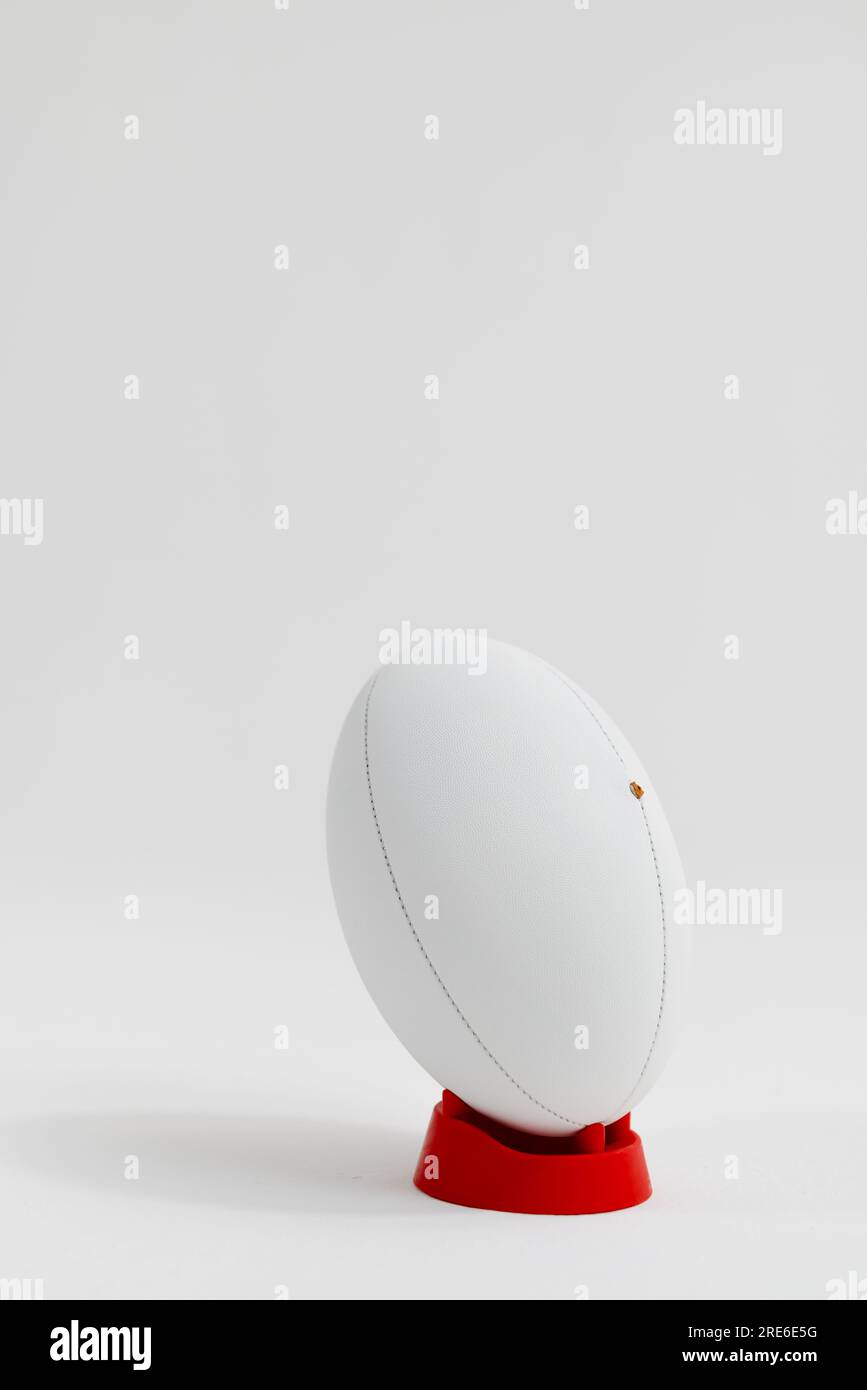 White rugby ball on red stand with copy space on white background Stock ...
