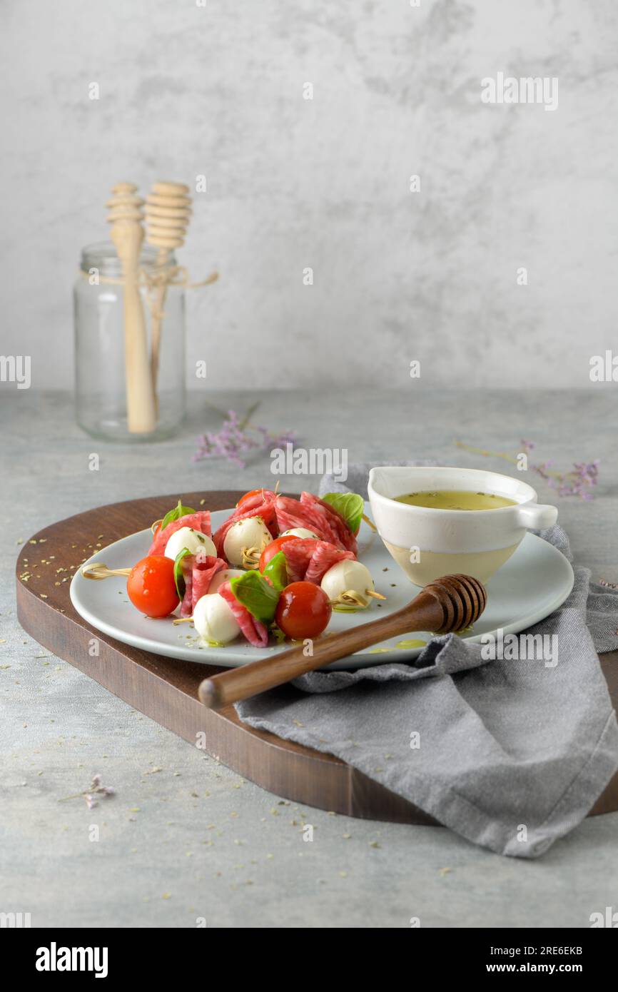 Italian style appetizer, antipasto skewer or caprese on a stick with ...