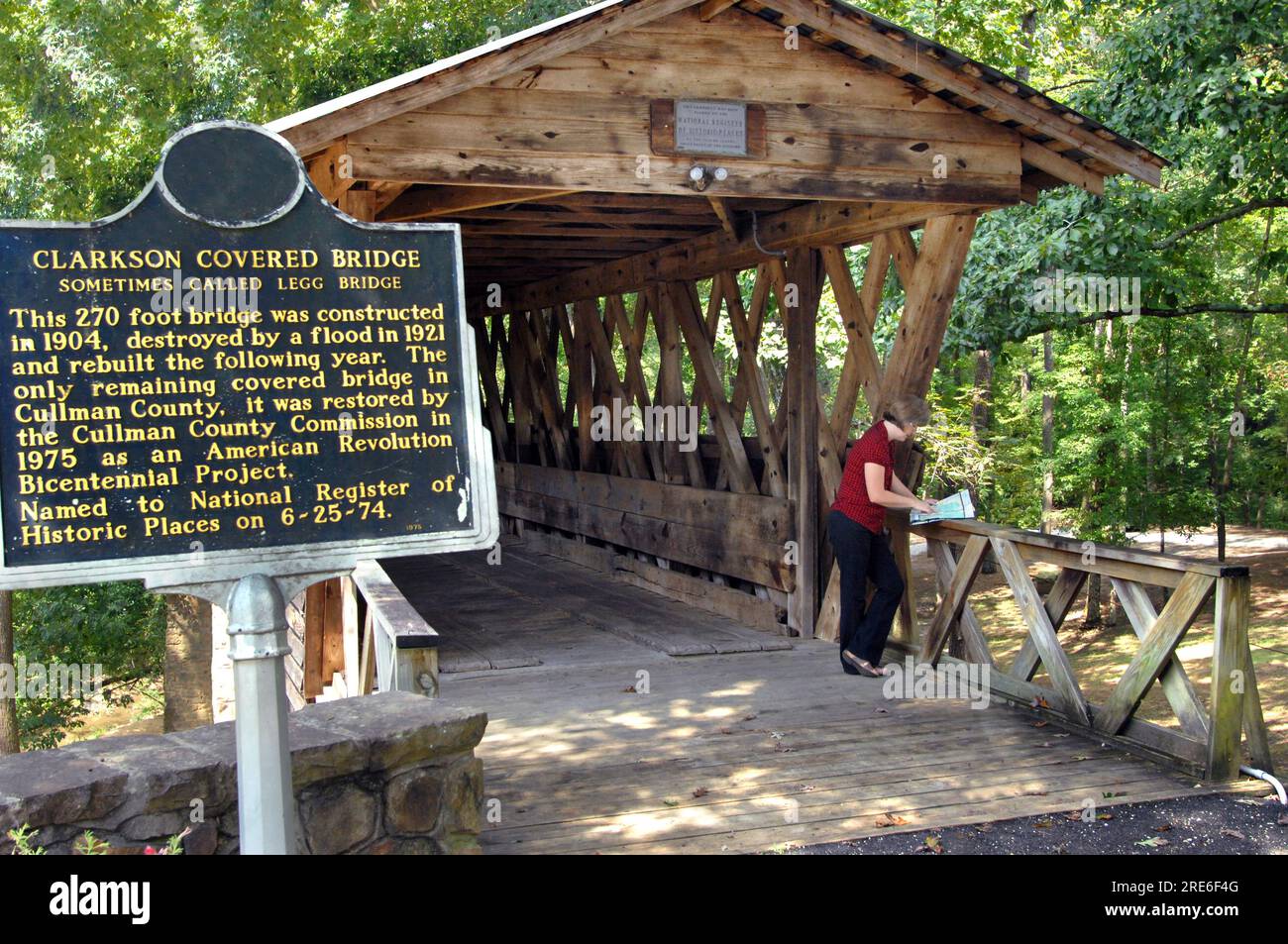 Female visitor to the Clarkson Covered Bridge looks at map of the area ...