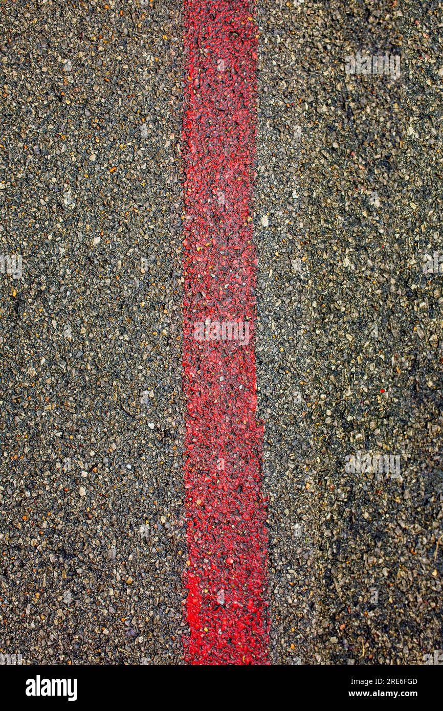 Dark asphalt road background or texture, red line passing through ...