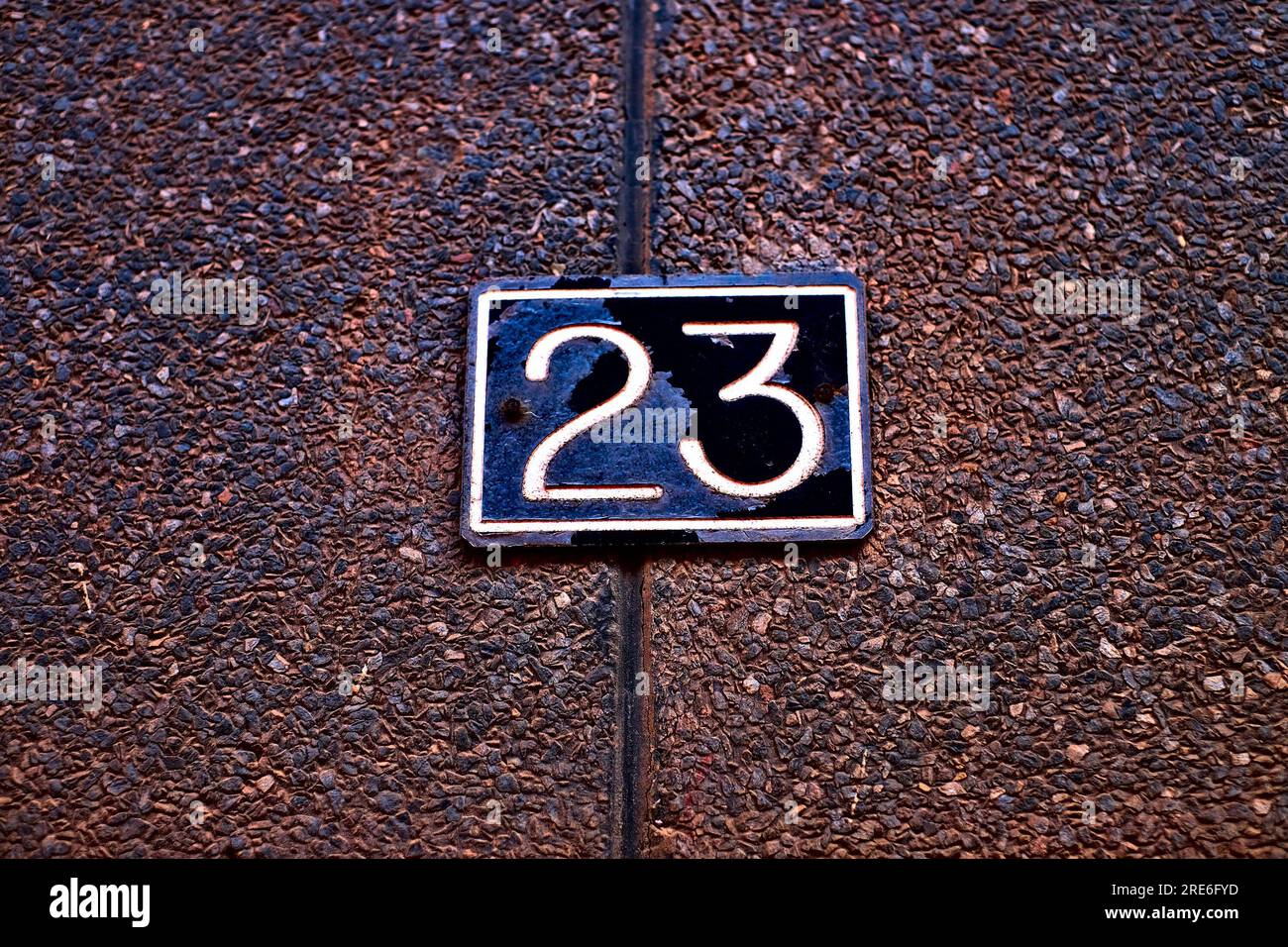 Number 23, twenty-three, white digits on a dark plate, dark brown ... Number 23, twenty-three, white digits on a dark plate, dark brown ...