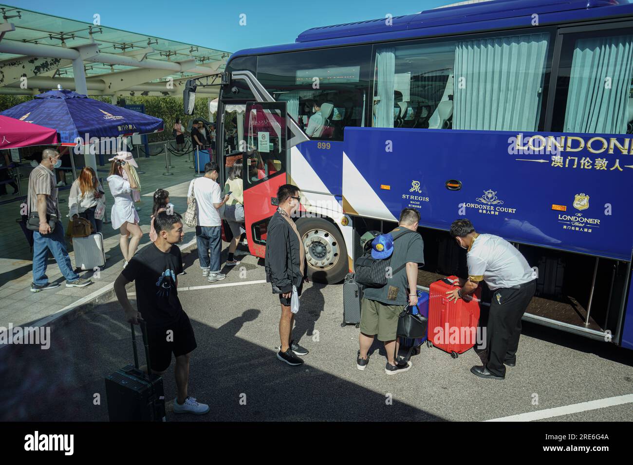 People board on a bus at Taipa Ferry Terminal. Daily life in Macao ...
