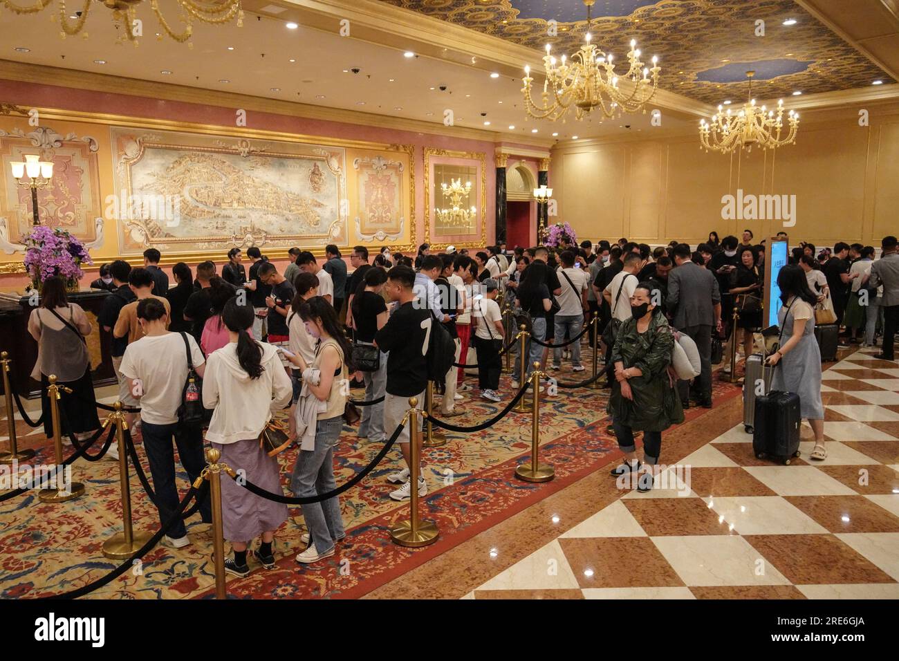 Macau, China. 24th July, 2023. People line up to check in inside The ...