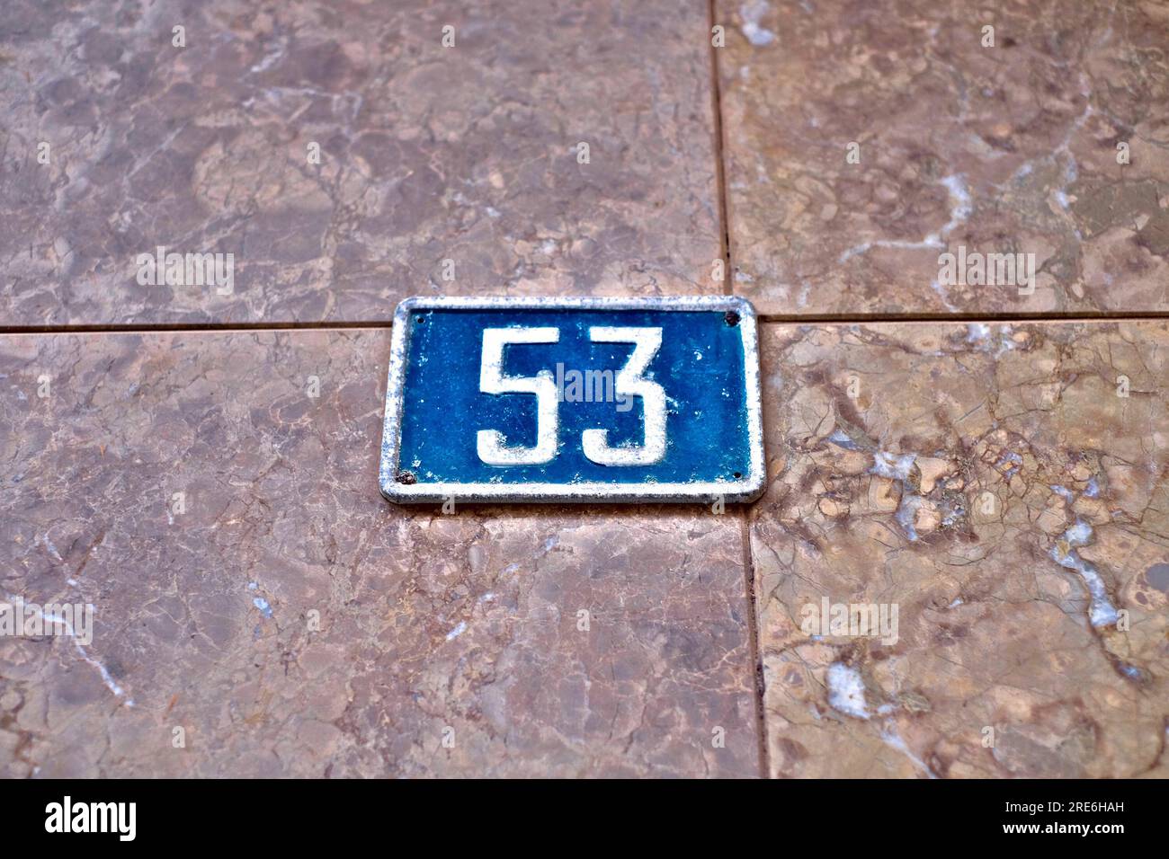 Number 53, fifty-three, white digits on a blue plate, exterior wall ...