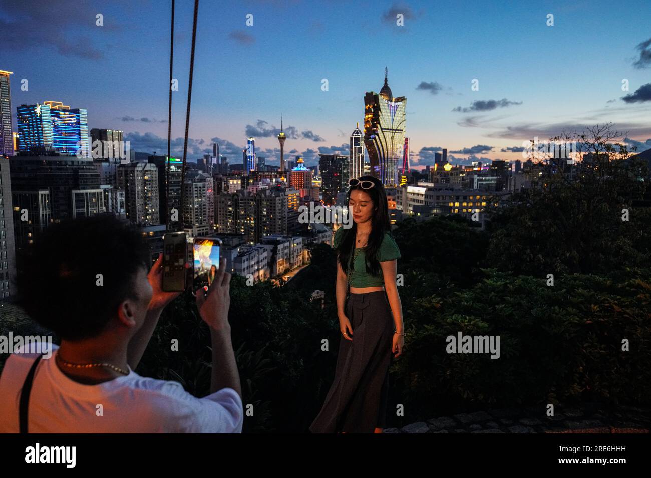 Macau, China. 24th July, 2023. Tourists take photos at Guia Lighthouse ...