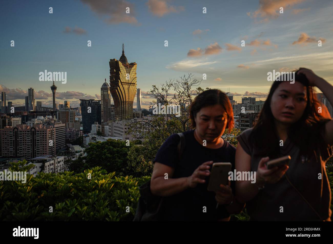 Macau, China. 24th July, 2023. Two women stand at Guia Lighthouse with ...