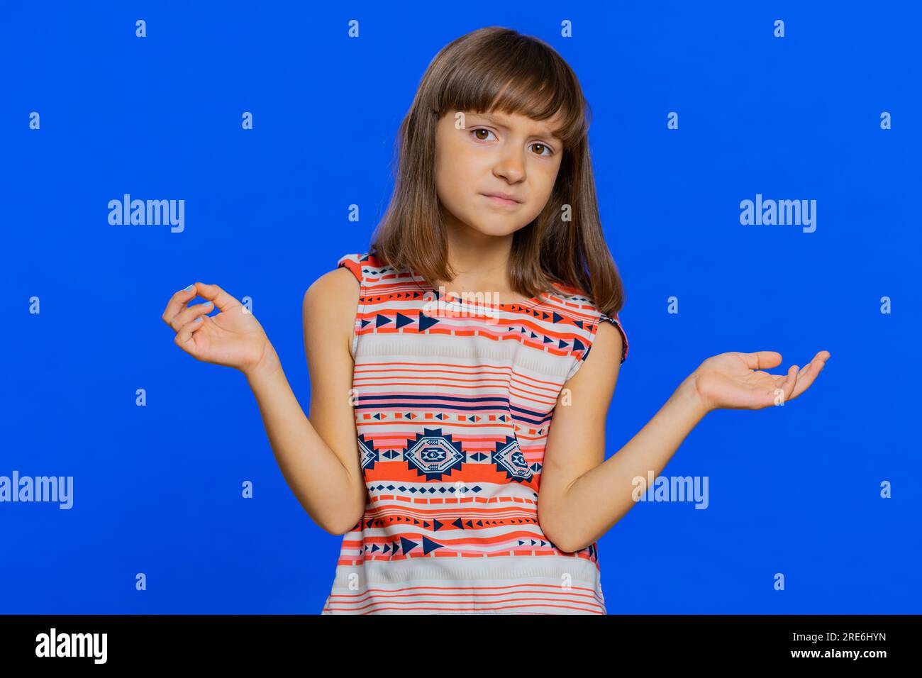What. Why. Young brunette school girl raising hands in indignant ...