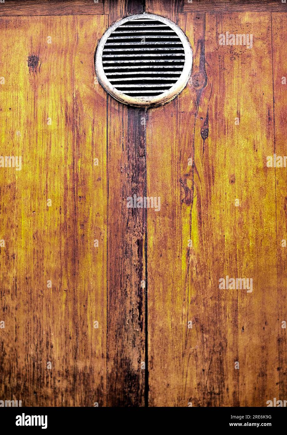 Big round vent hole in old elegant timber door Stock Photo - Alamy