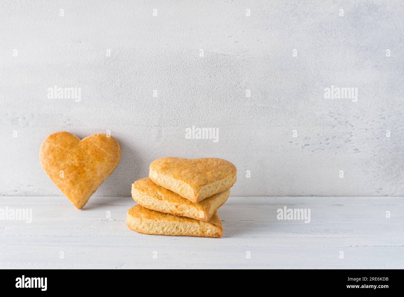 Shortbread cookies in the shape of a heart on a light blue background ...