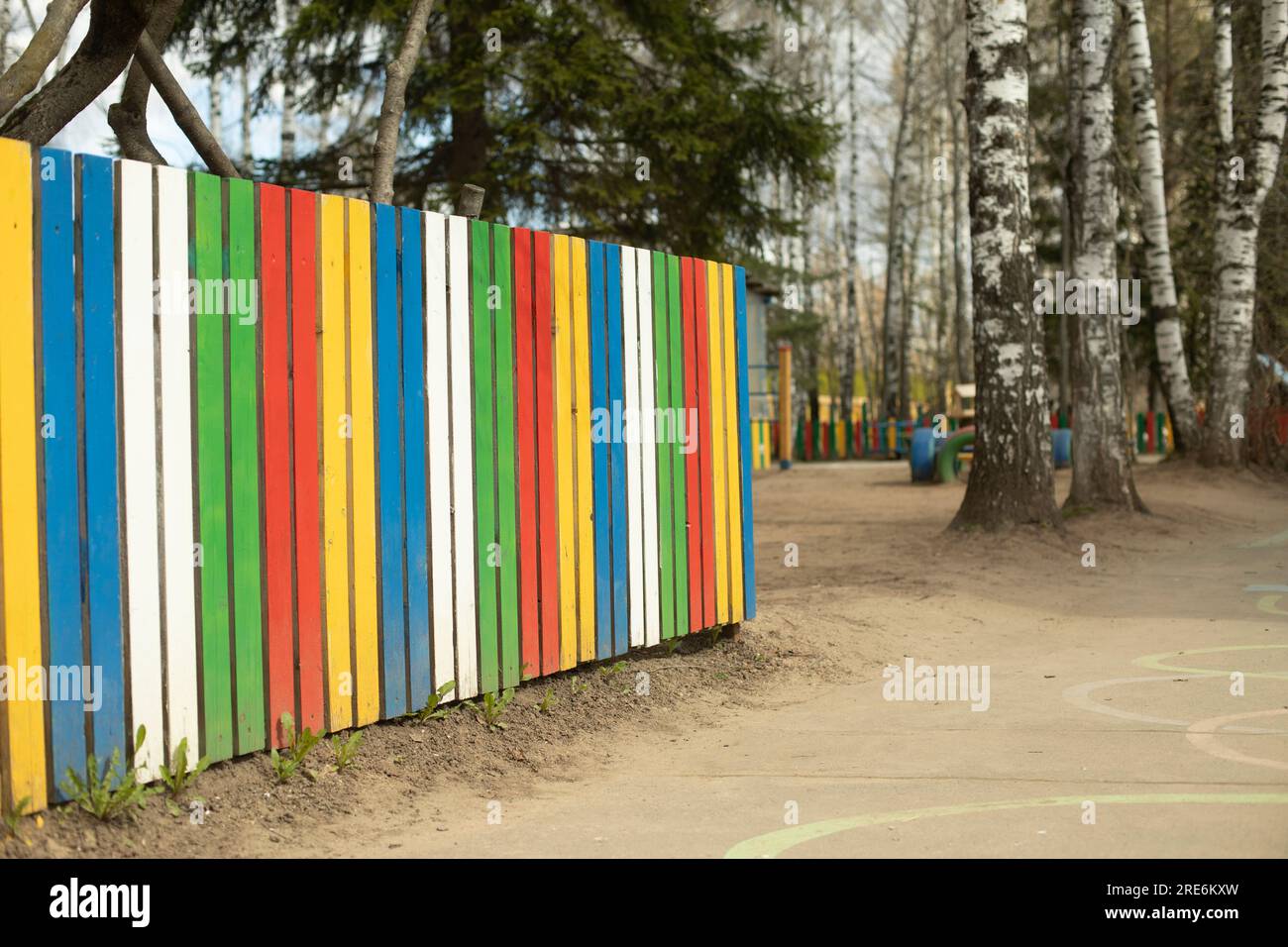 Colored fence in garden. Children's fence. Colorful board. Fun yard ...