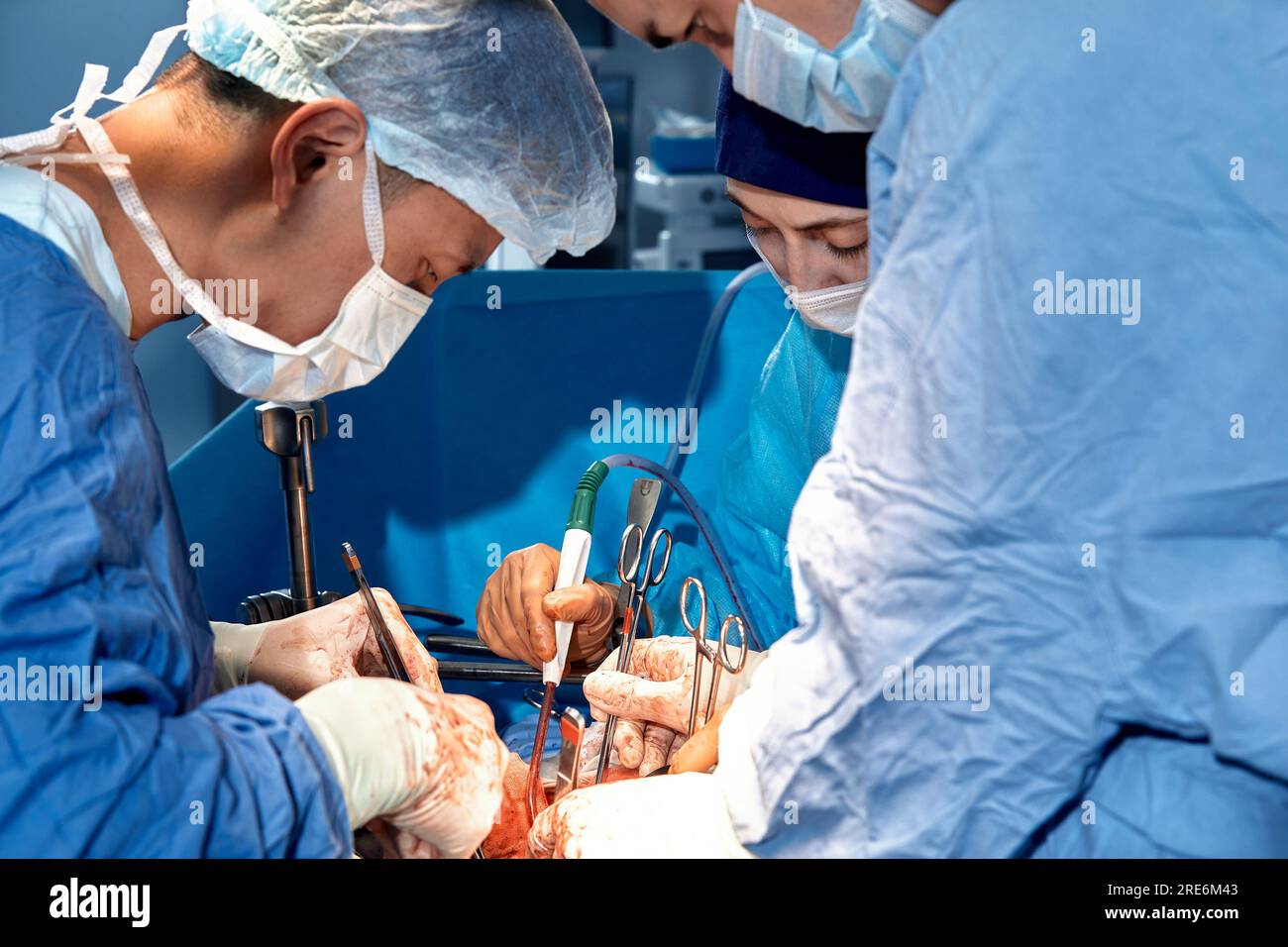Surgeons team during complex surgical operation in a sterile operating ...