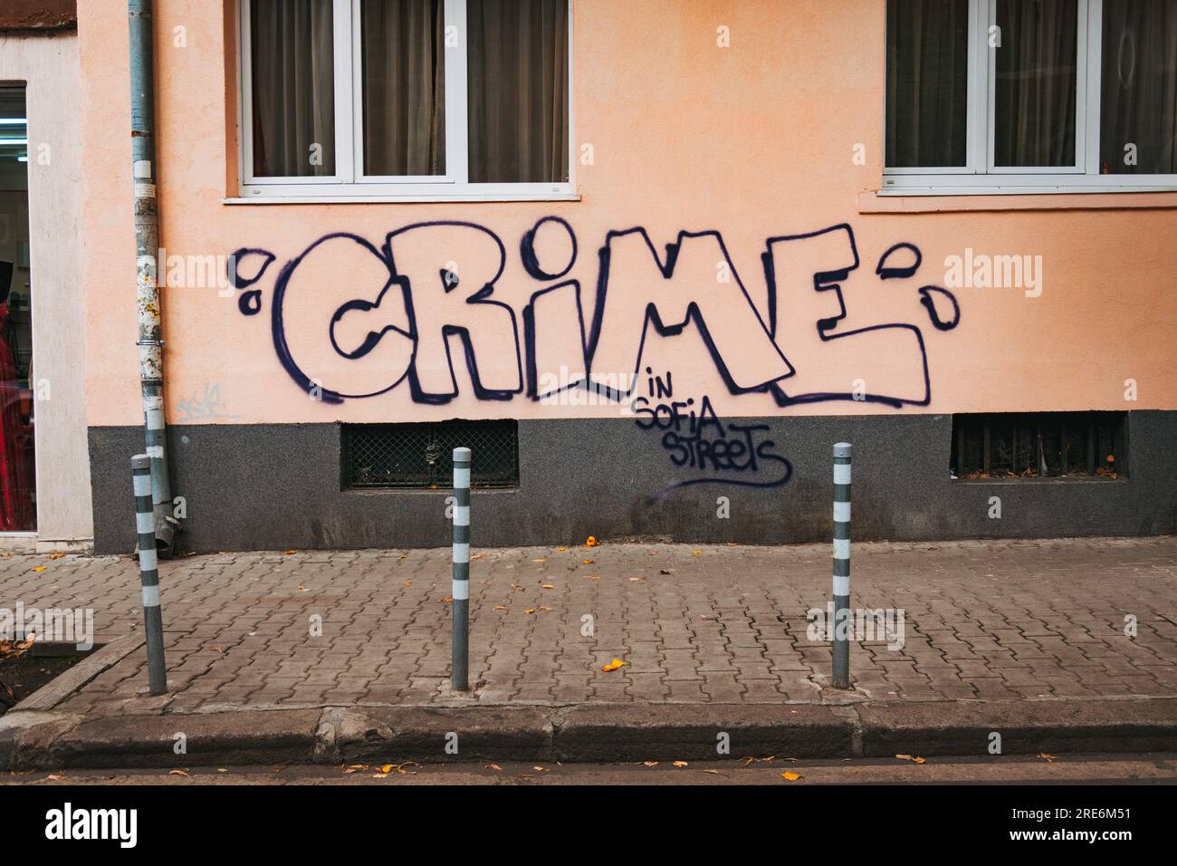an ironic graffiti of the word "crime" on a building wall in Sofia ...