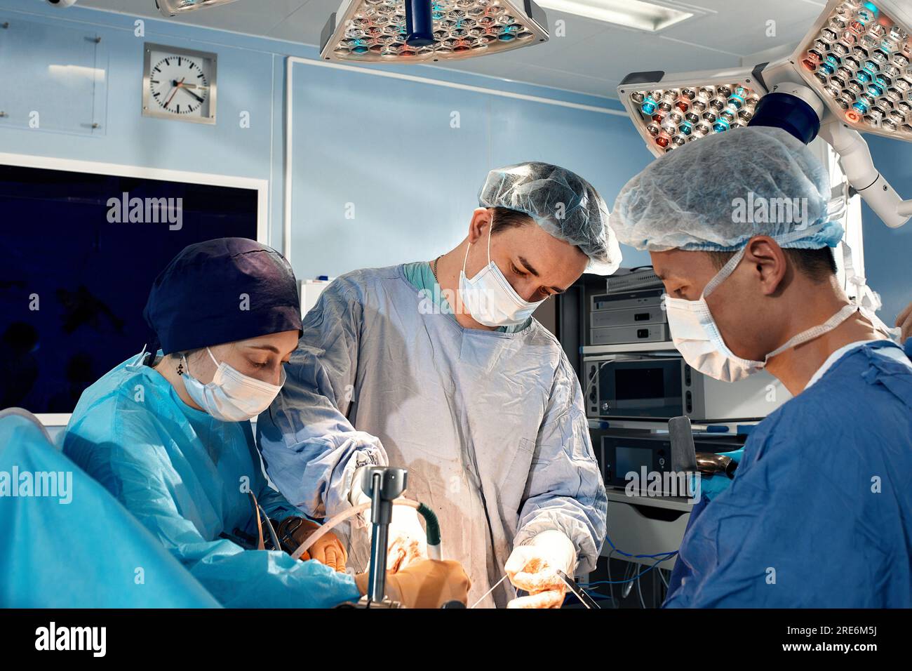 Surgeons team during complex surgical operation in a sterile operating ...