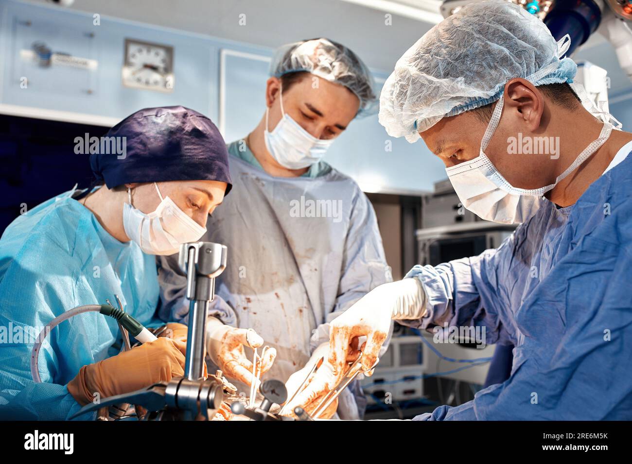 Surgeons team during complex surgical operation in a sterile operating ...