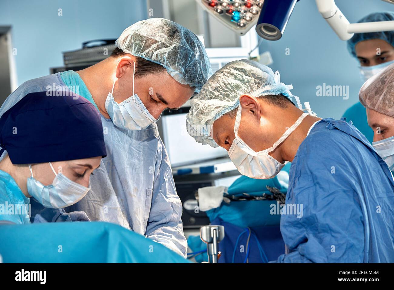 Surgeons team during complex surgical operation in a sterile operating ...
