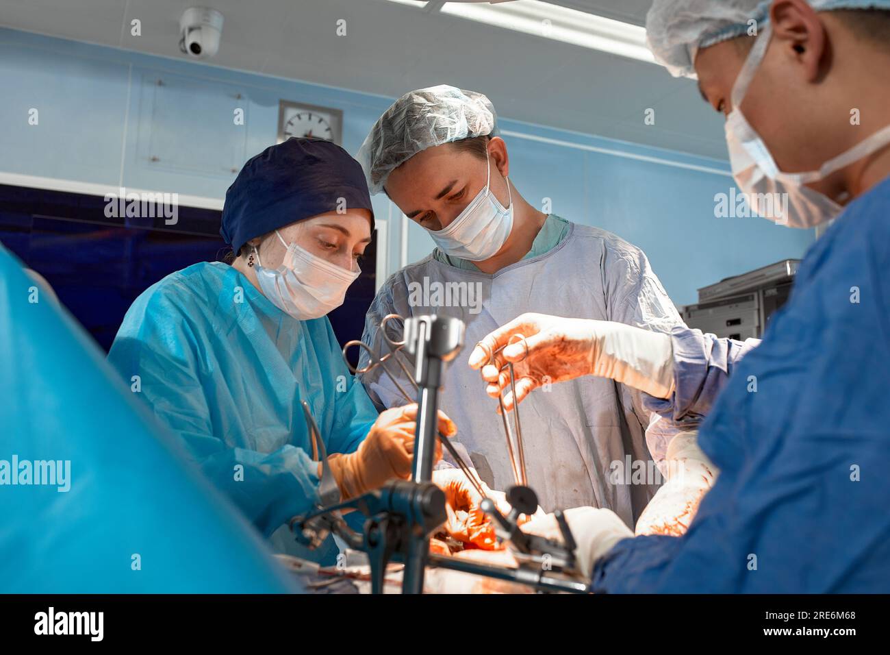 Surgeons team during complex surgical operation in a sterile operating ...