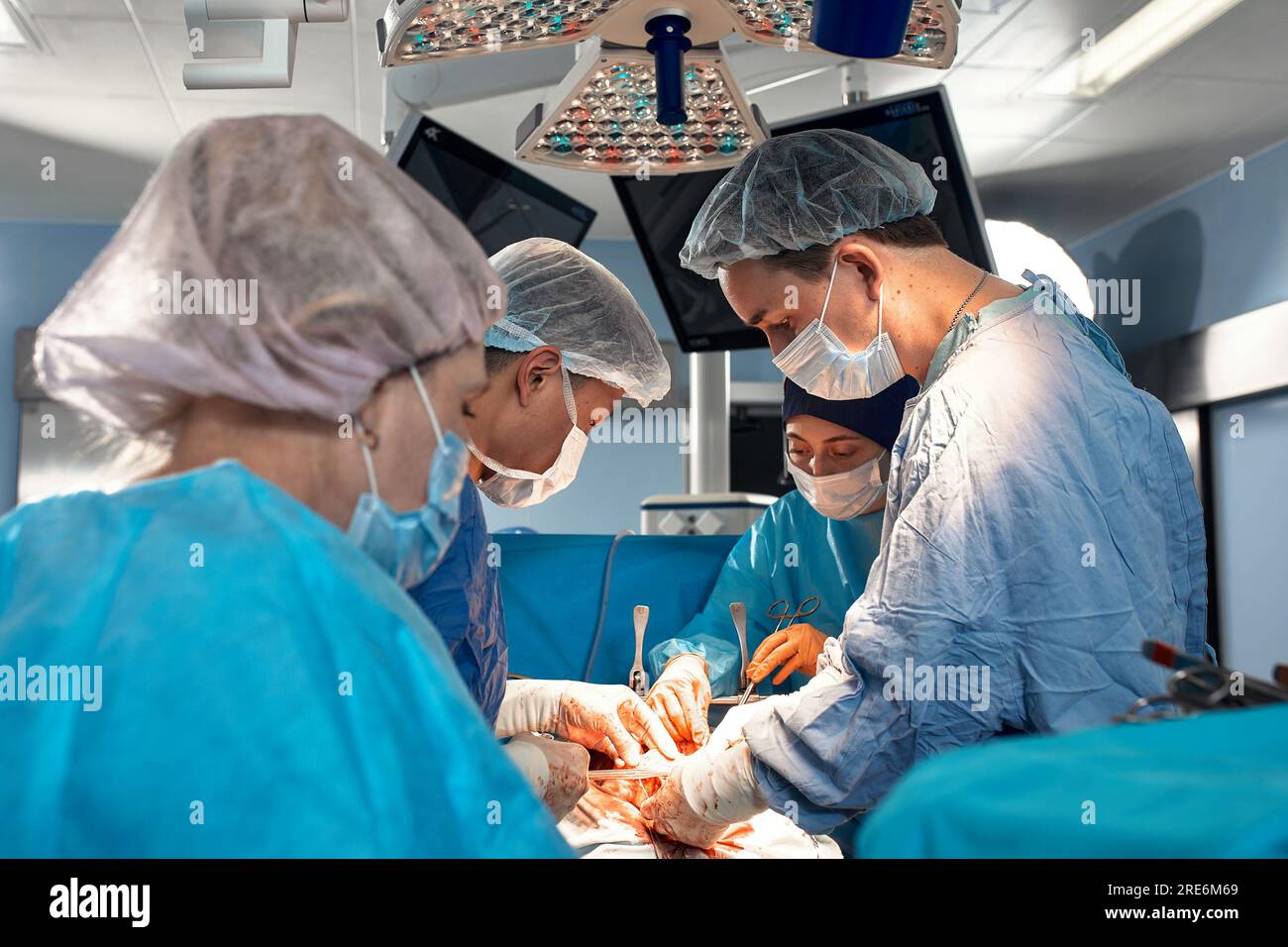 Surgeons team during complex surgical operation in a sterile operating ...