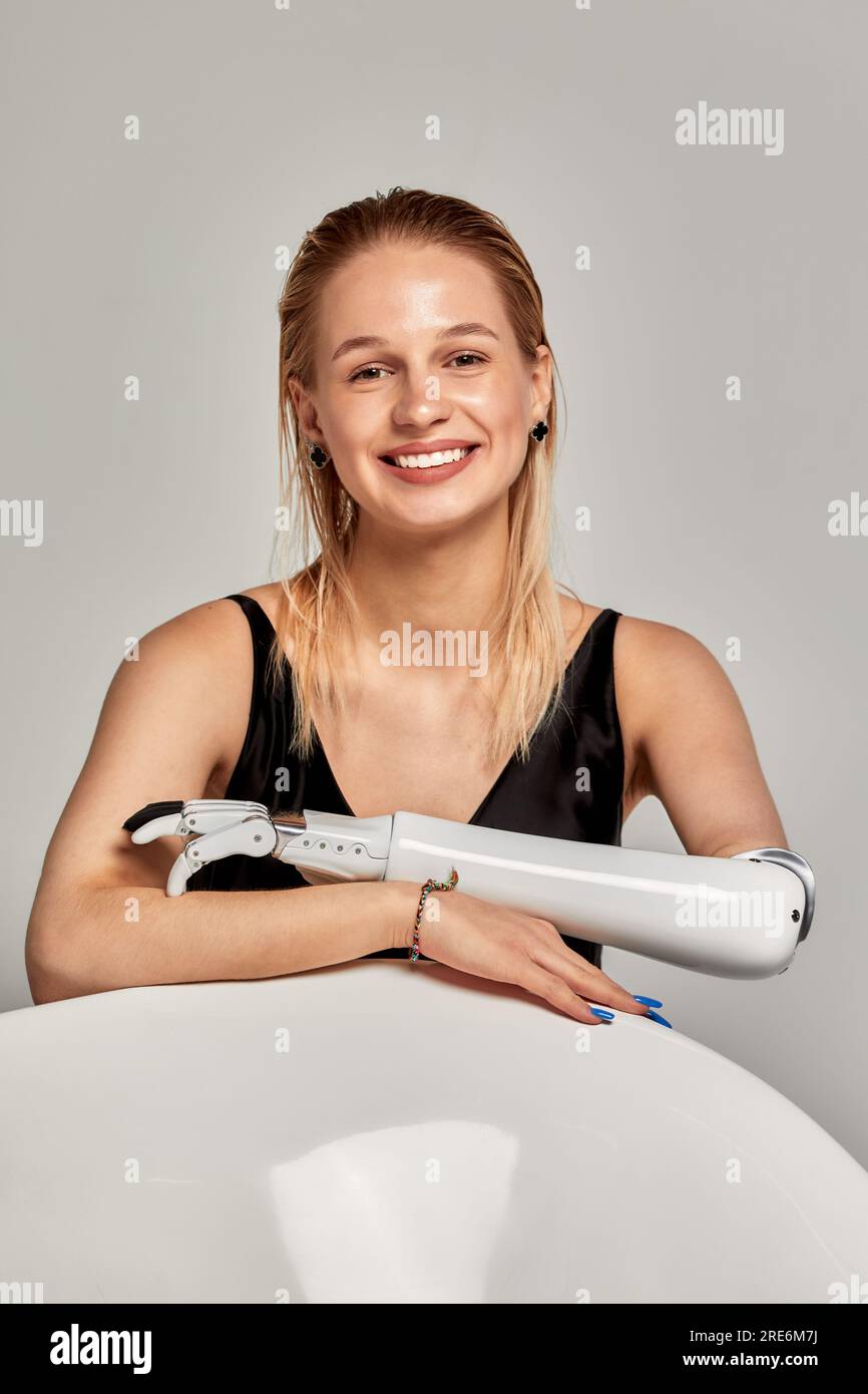Young charming girl with disability wearing sensory bionic prosthetic ...
