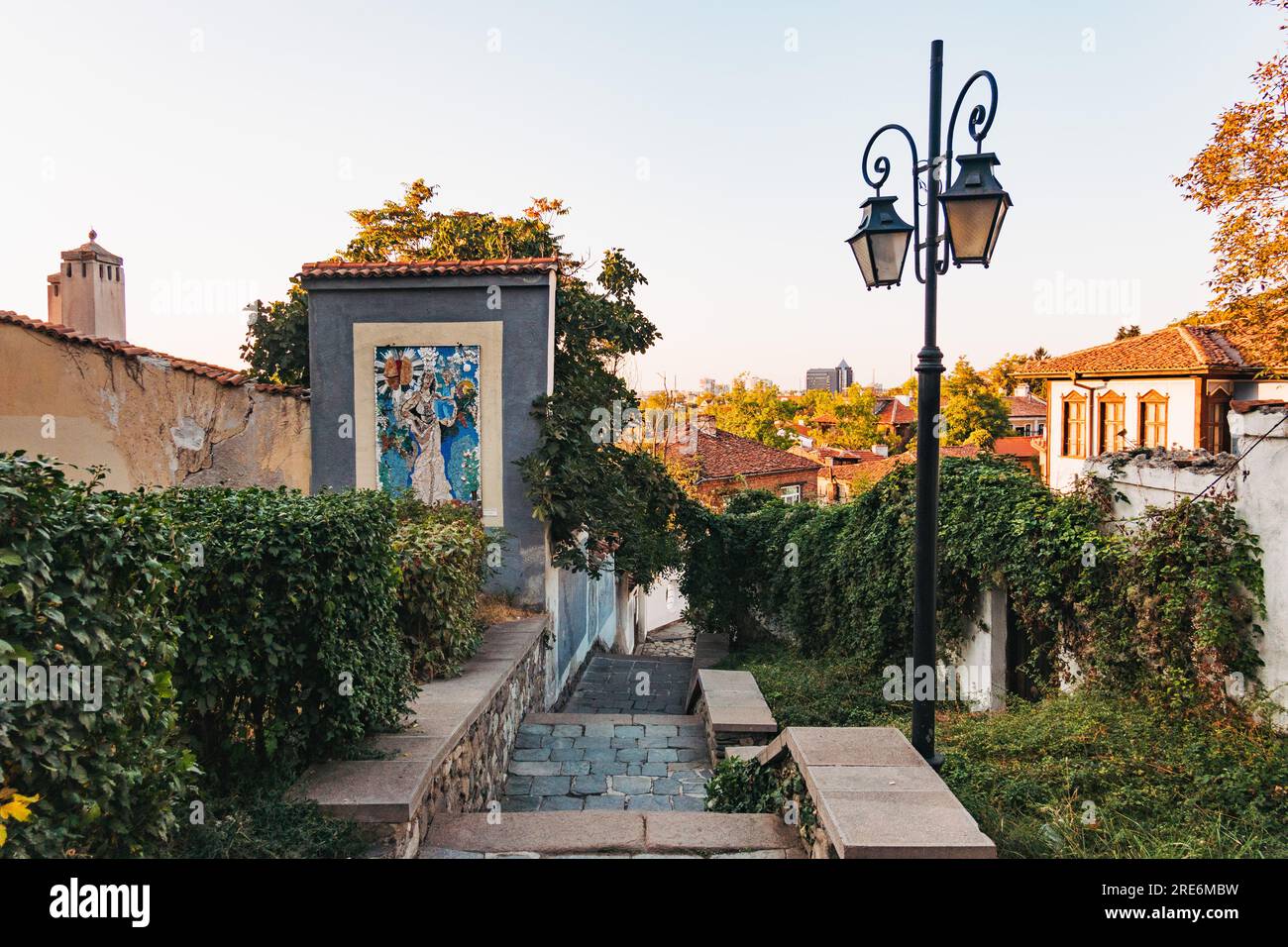 an ornate path and steps with a mural and lamp post in Plovdiv ...