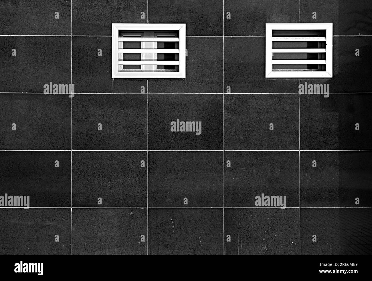 Two big vent holes in black wall, offset with space for text Stock ...