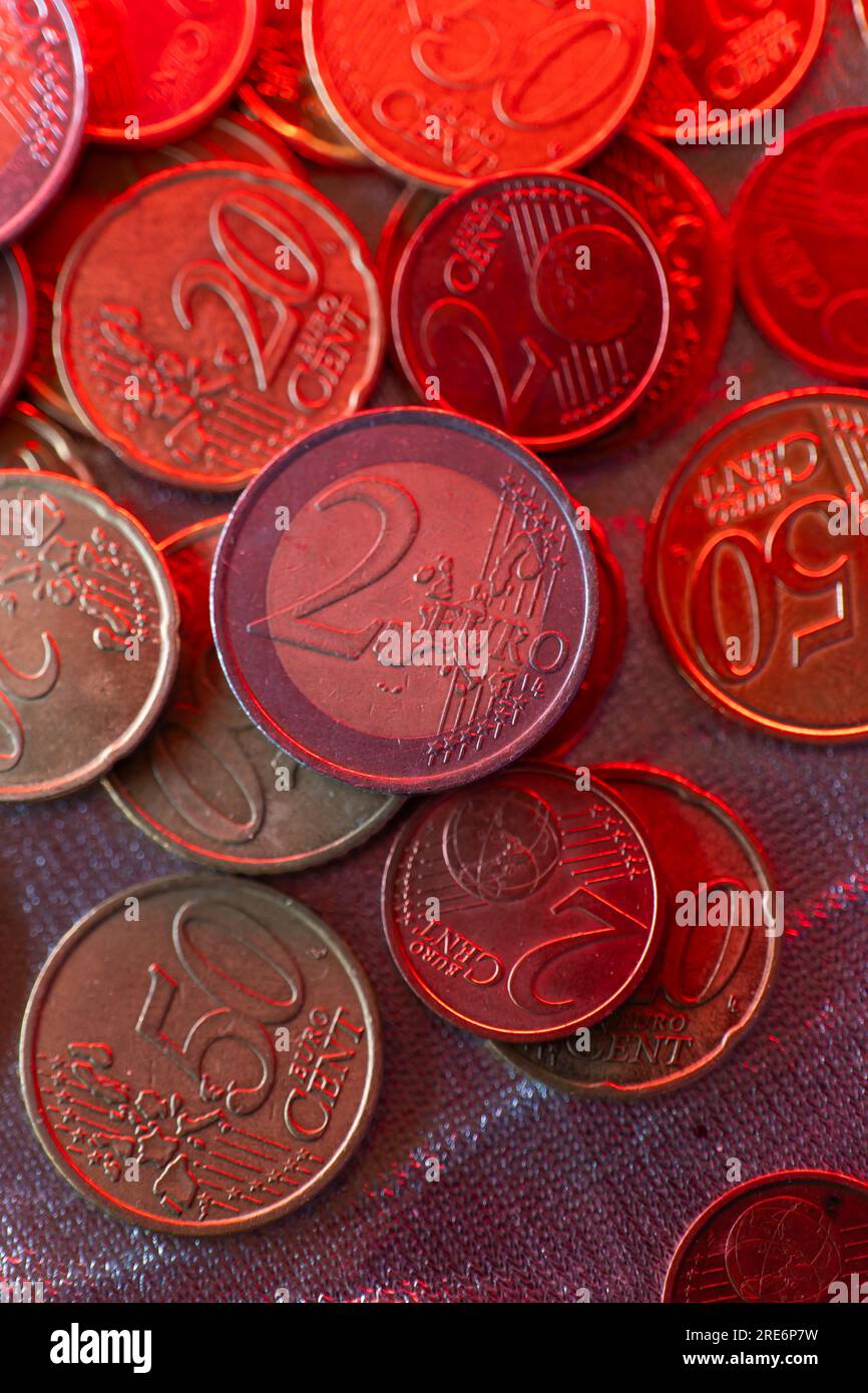 Money background.Euro cents in red light. Euro currency inflation.Money ...