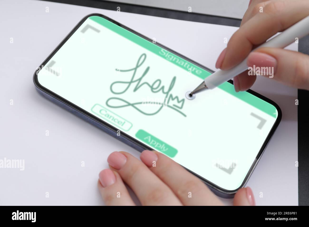 Electronic signature. Woman using stylus and mobile phone, closeup ...