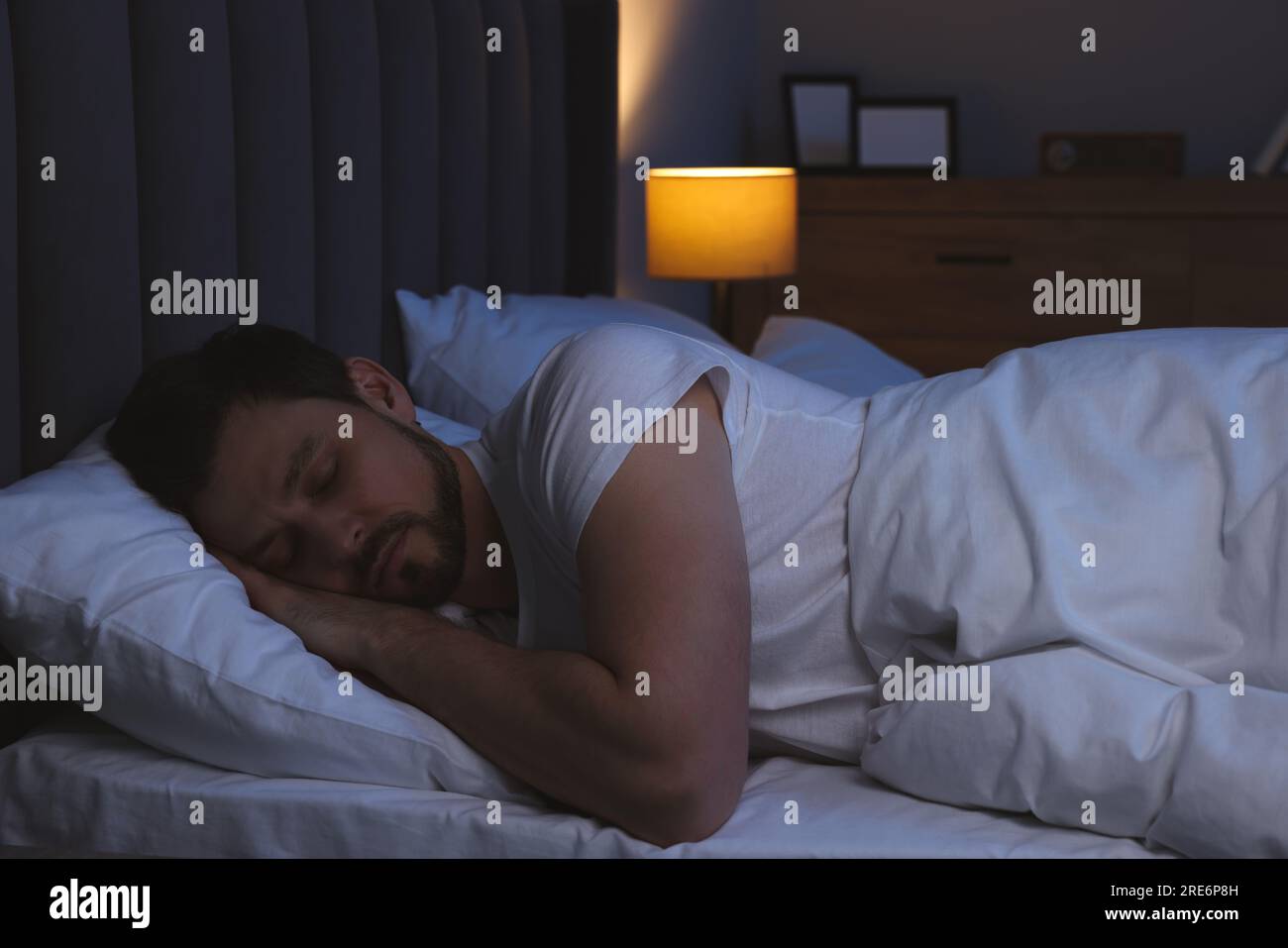 Handsome man sleeping in bed at night Stock Photo - Alamy