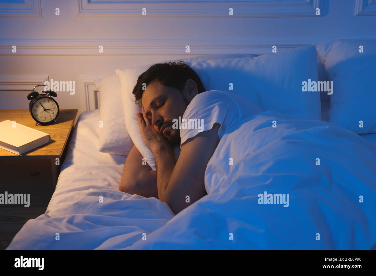 Handsome man sleeping in bed at night Stock Photo - Alamy