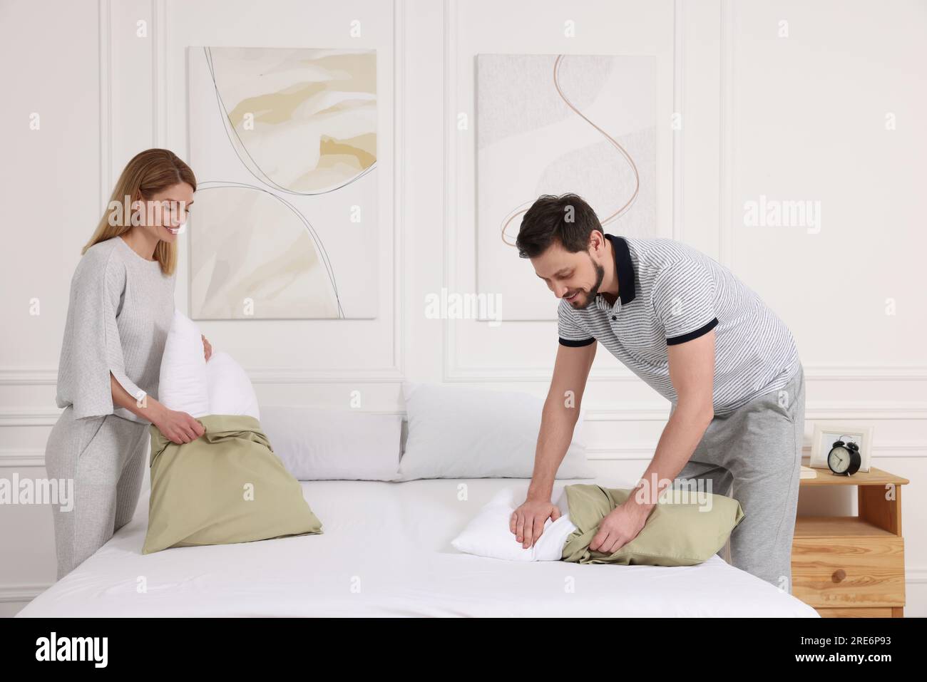 Couple changing bed linens at home. Domestic chores Stock Photo - Alamy
