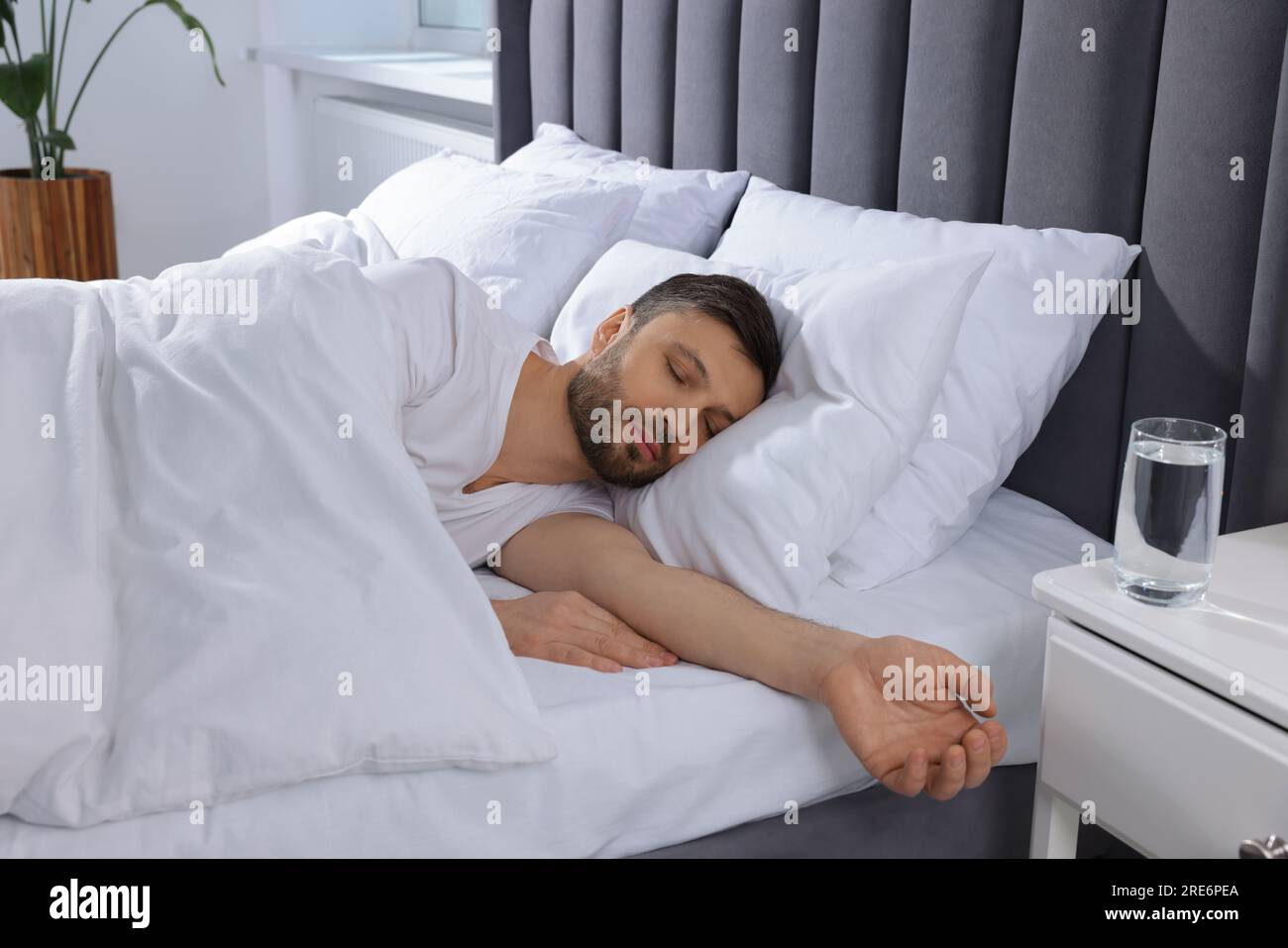 Handsome man sleeping in soft bed at home Stock Photo - Alamy