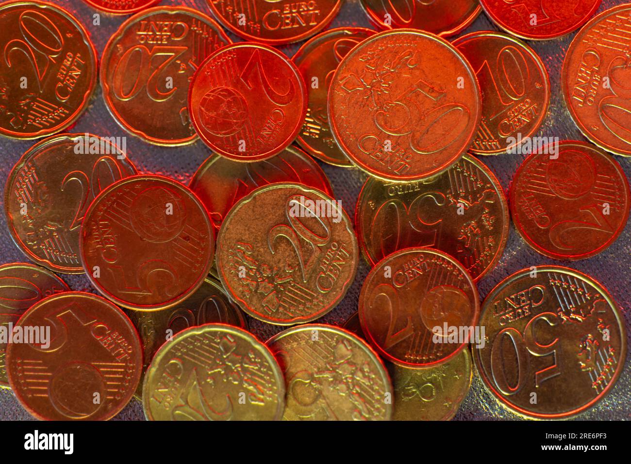 Money background.Euro cents in red light. Euro currency inflation.Euro ...