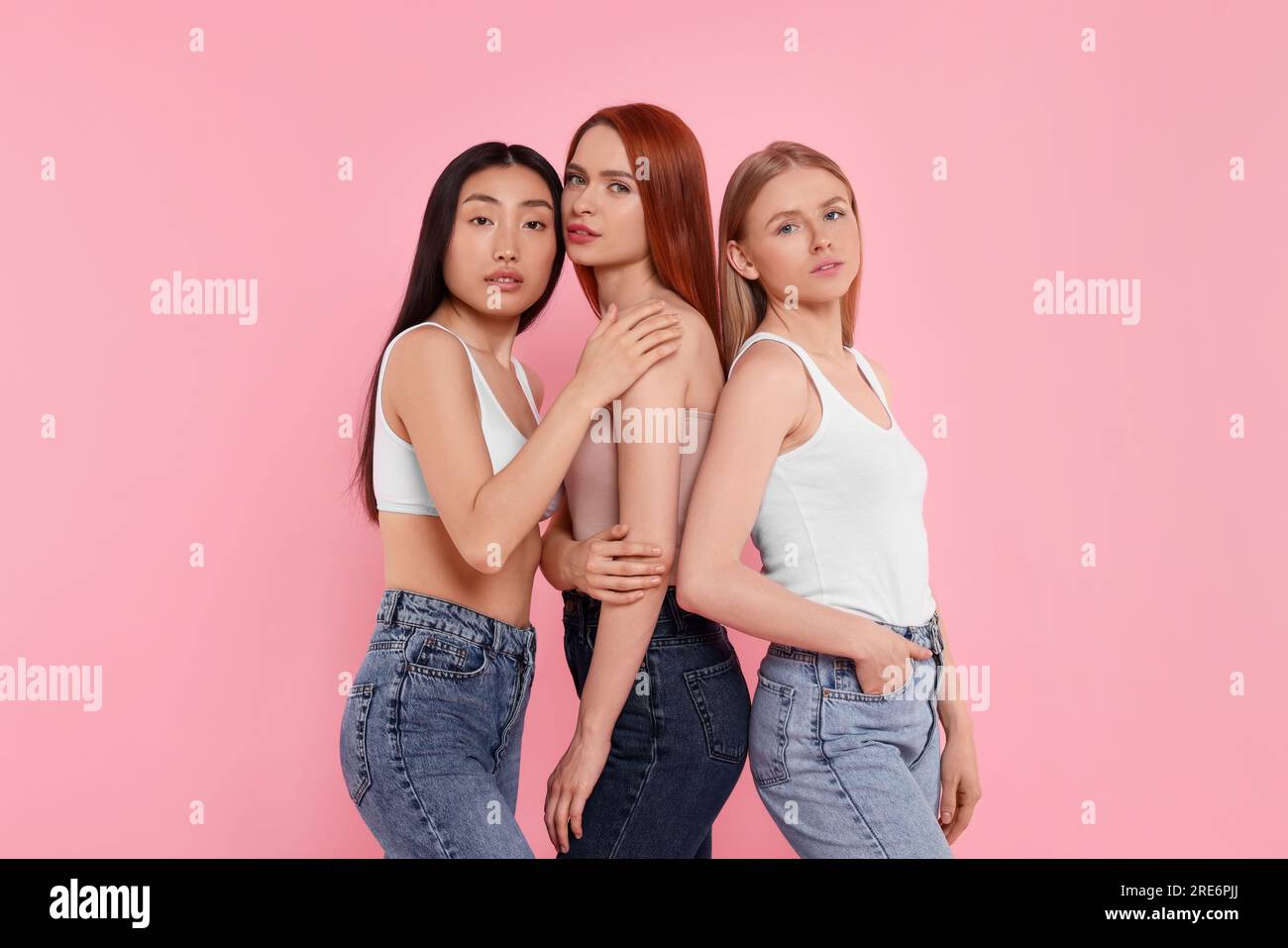 Portrait of beautiful young women on pink background Stock Photo - Alamy