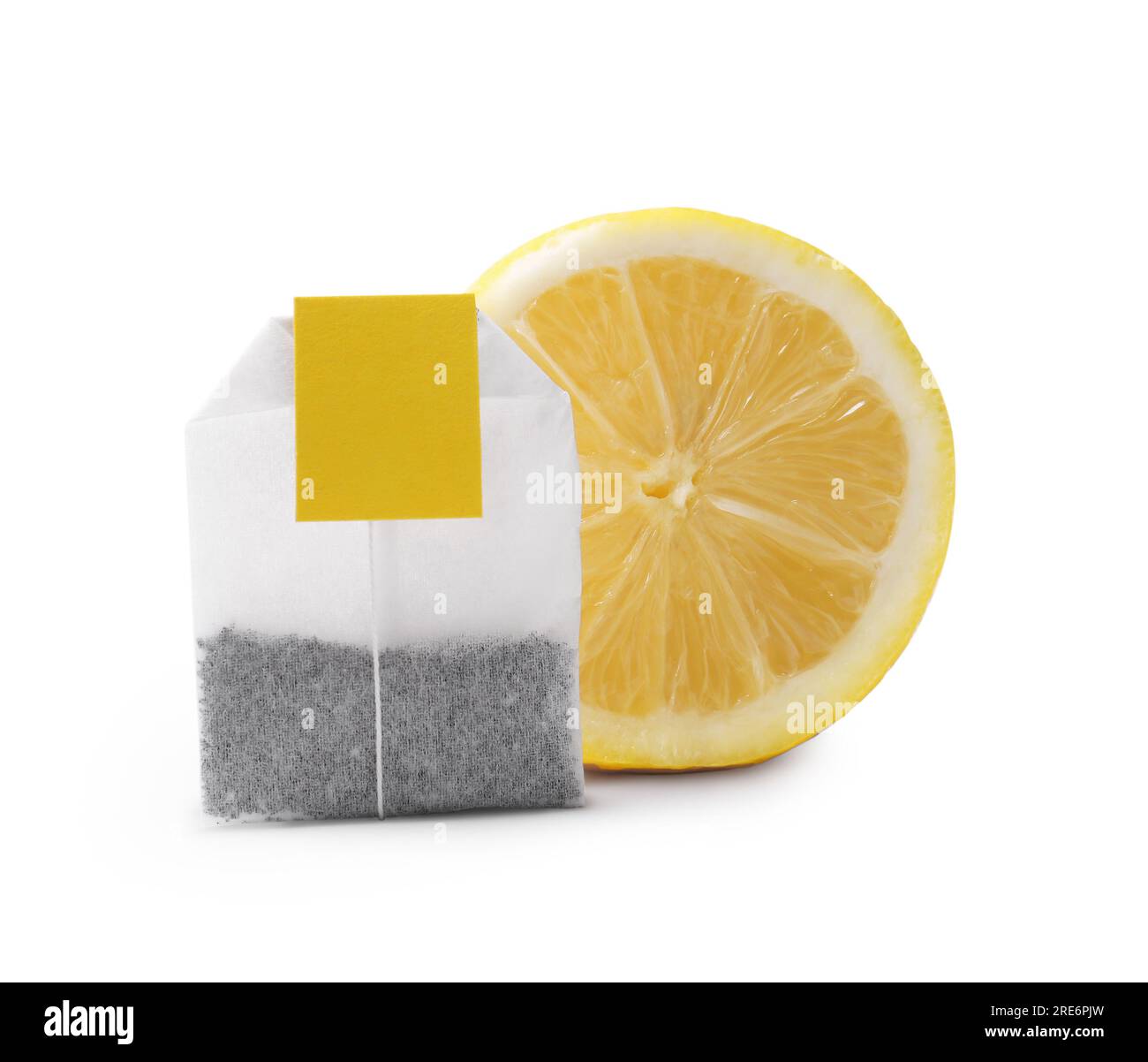 New tea bag with label and half of lemon on white background Stock ...