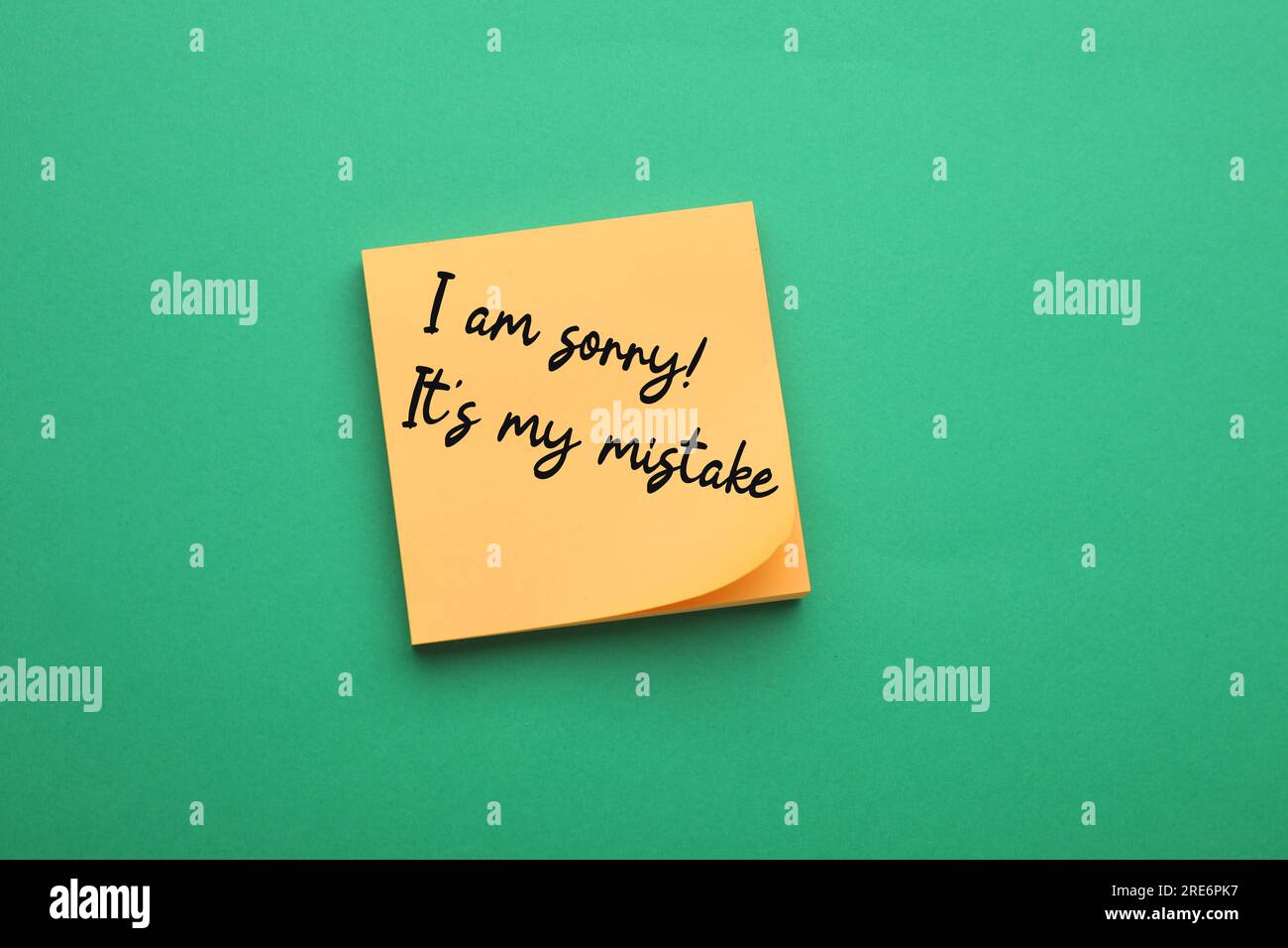 Orange sticky note with phrase I Am Sorry, It's My Mistake on green ...