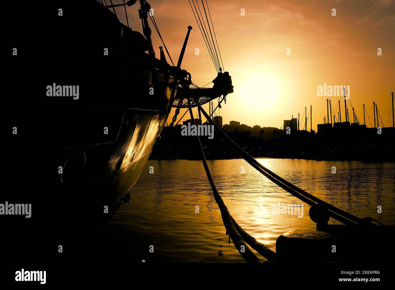 Silhouette of a sailing ship in the sunset. A ship in her home port ...