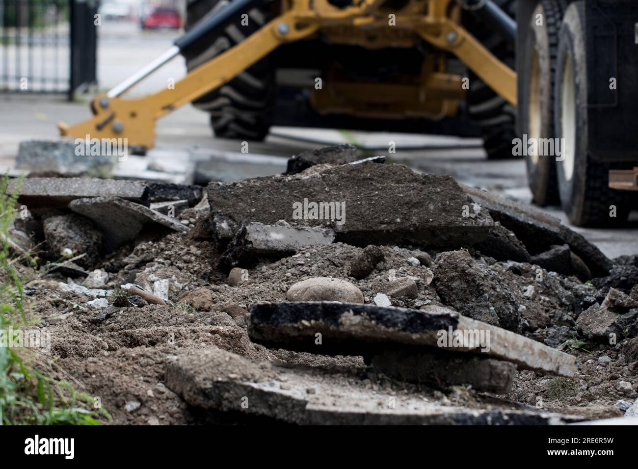 Construction work excavator tearing up sidewalk Stock Photo - Alamy