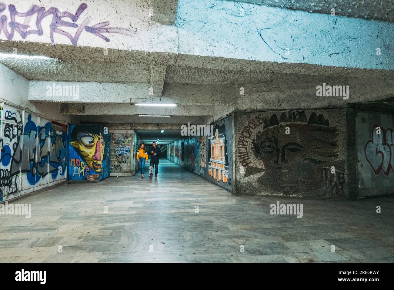 a concrete underground pedestrian walkway in Plovdiv, Bulgaria, covered ...