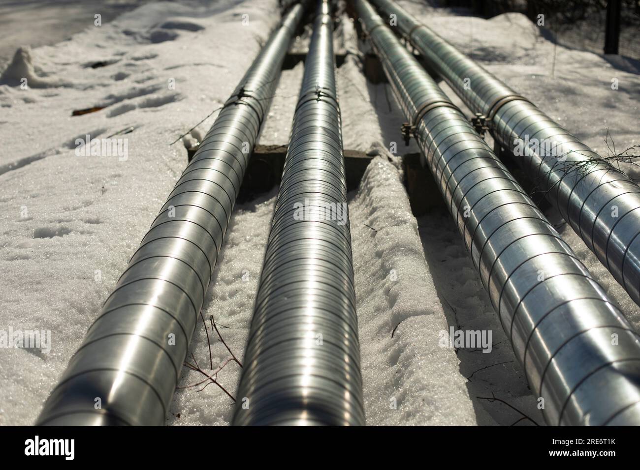 Pipes on street in winter. Steel heating pipes. Industry details. Communications in city Stock ...