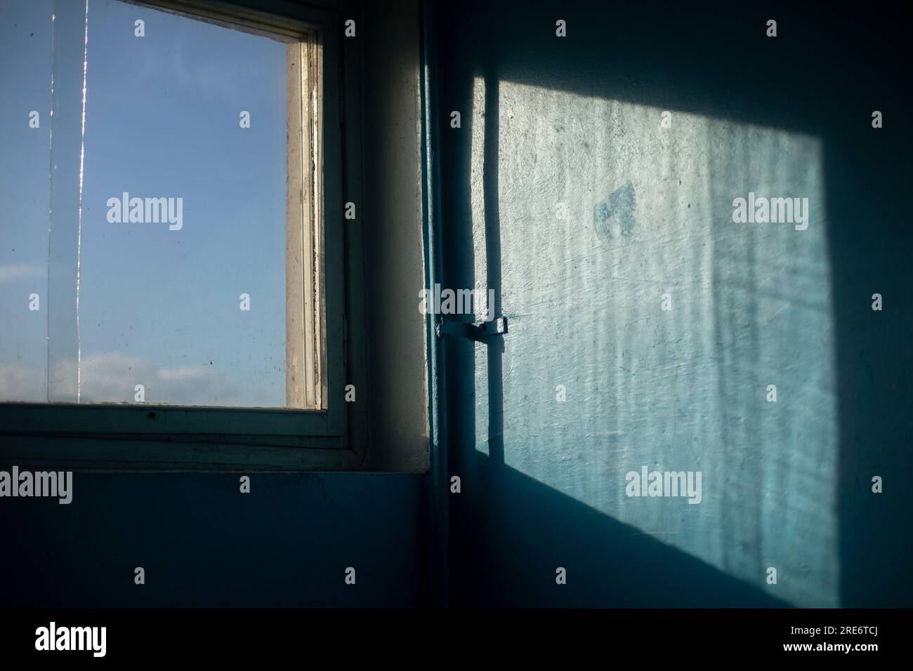 Light from window on wall. Light on blue wall. Interior details. Deep ...
