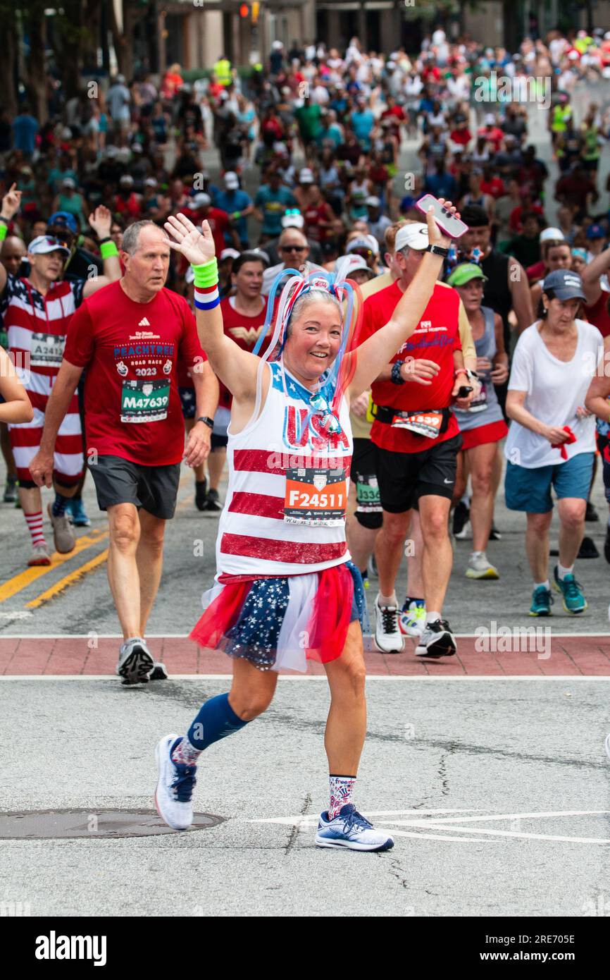Atlanta, GA / USA - July 4, 2023: A female runner decked out in red ...