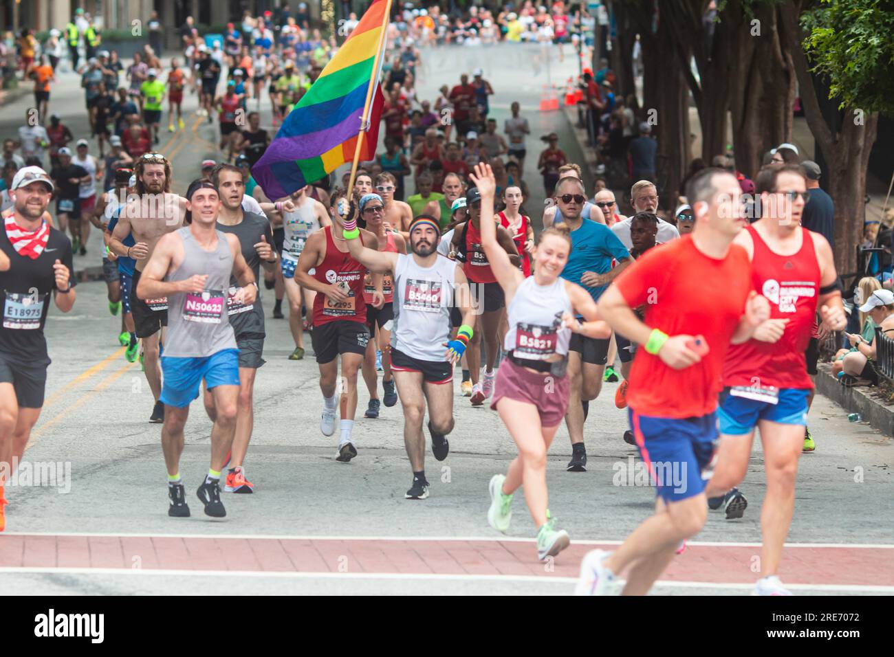 Atlanta, GA / USA – July 4, 2023: A man carries the rainbow LGBTQ flag ...