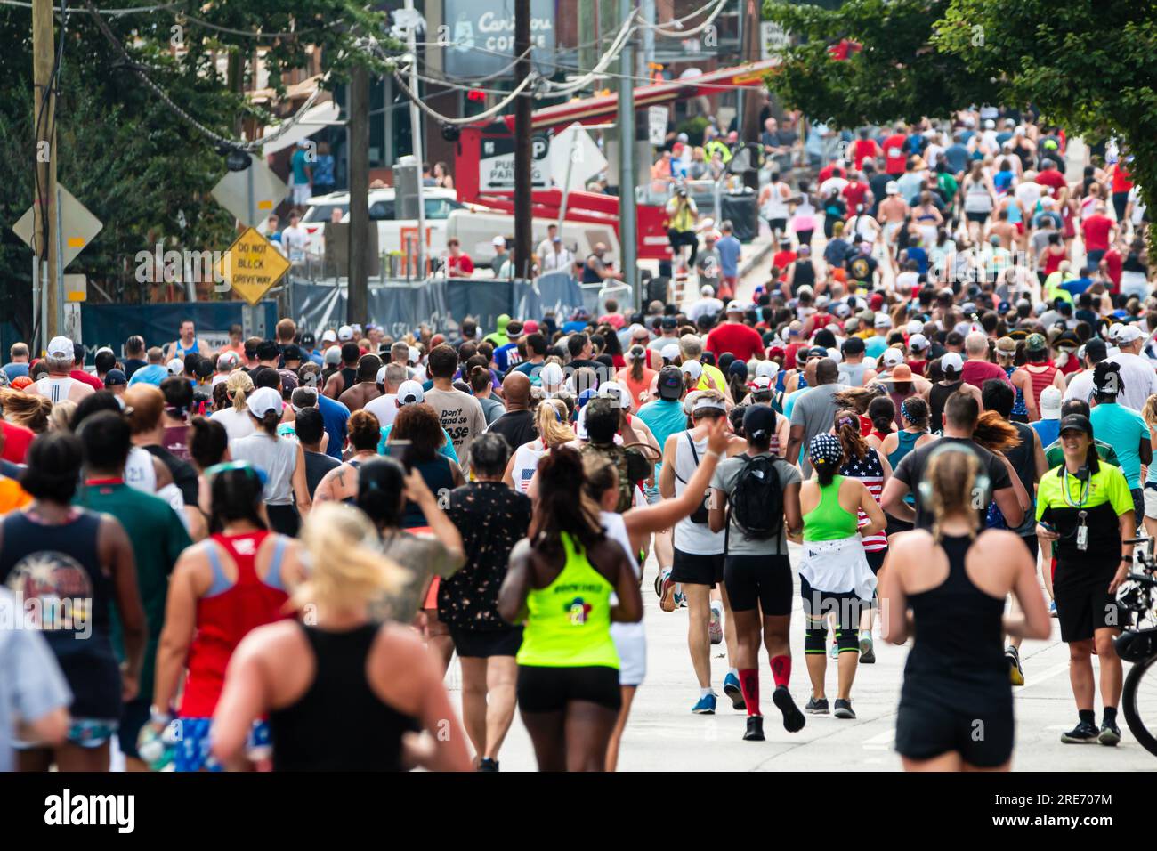 Atlanta, GA / USA - July 4, 2023: Thousands of runners plod toward the ...