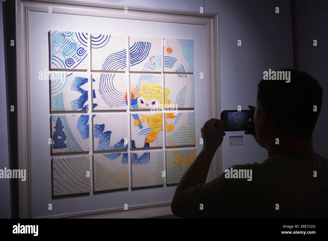 HANGZHOU, CHINA - JULY 25, 2023 - Visitors look at an embroidery work ...