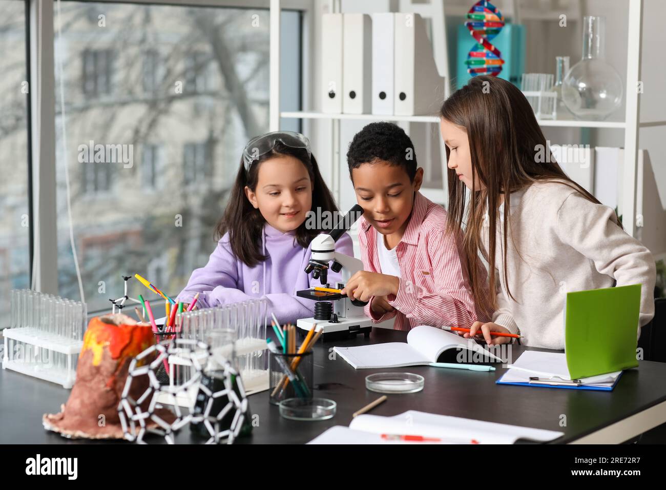 Little children with molecules studying Chemistry in science classroom ...