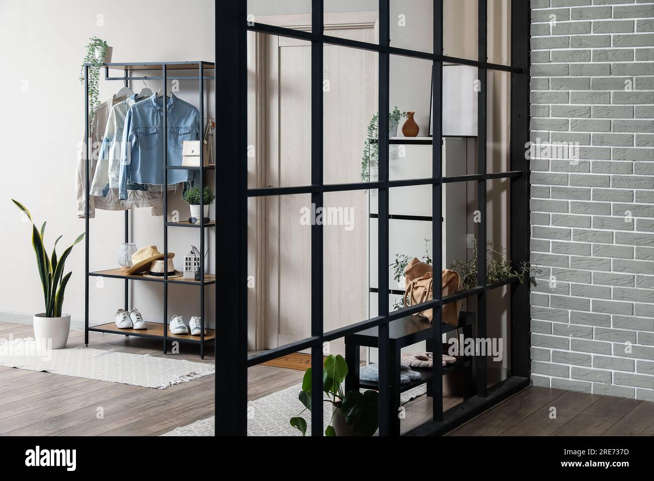 Shelving unit with clothes and accessories in interior of modern hall ...