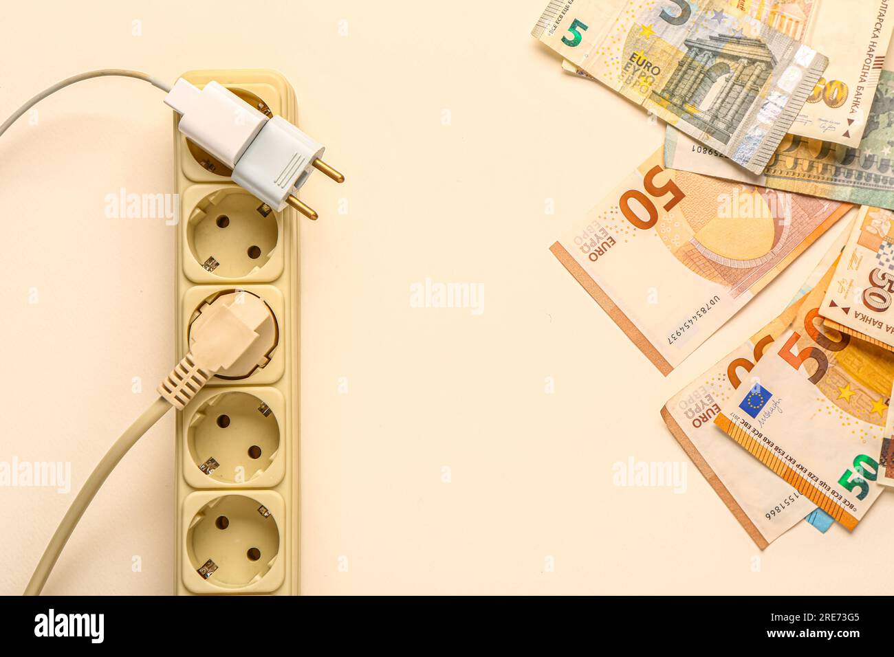 Power socket with plugs and money on white background. Electricity bill ...