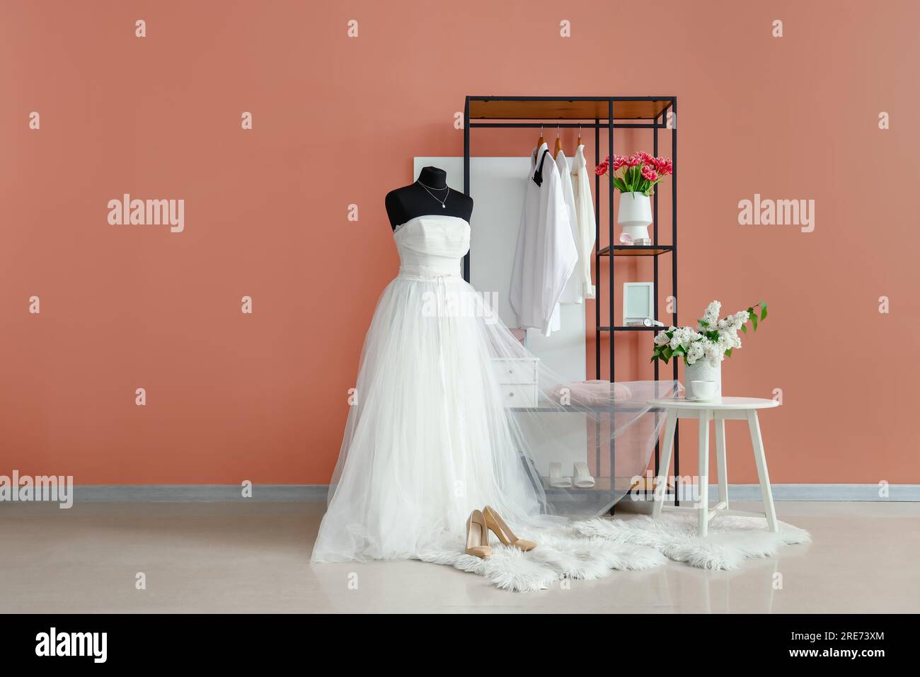 Mannequin with wedding dress and shelving unit in room Stock Photo - Alamy