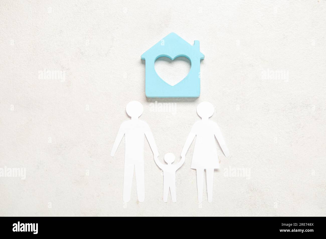 Figures of family with house on white background Stock Photo - Alamy