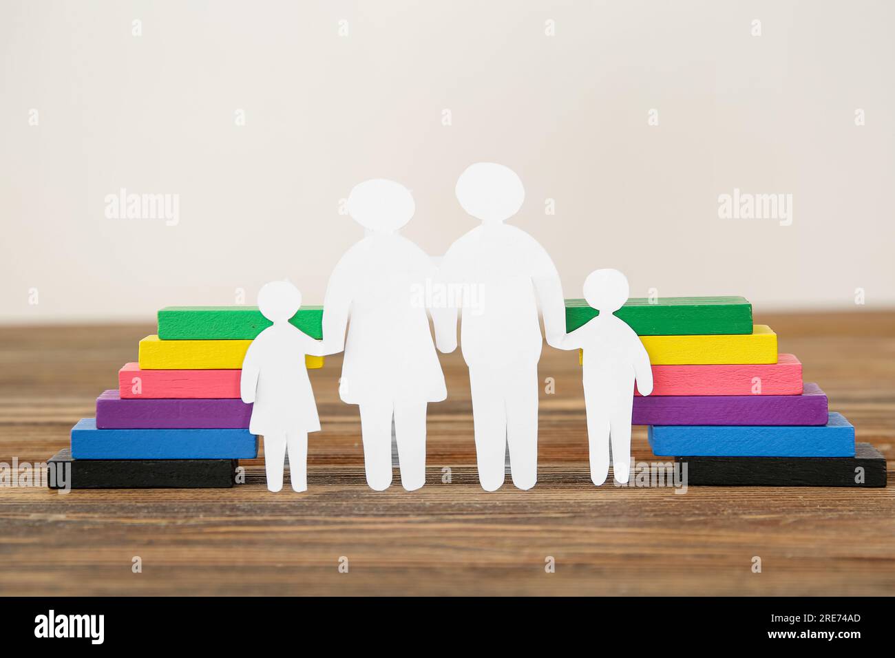 Figures of family and colorful blocks on brown wooden table Stock Photo ...