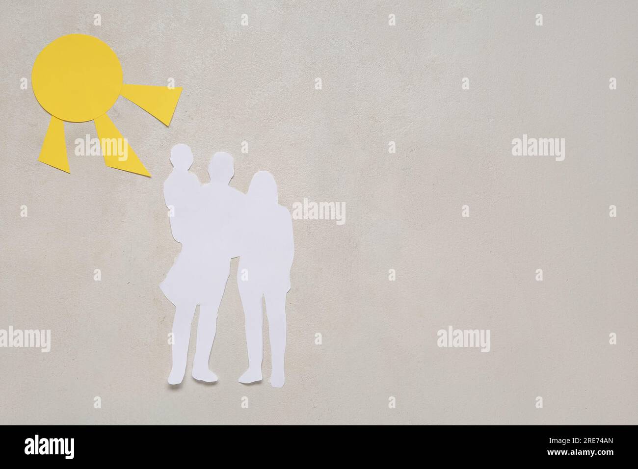 Figures of family with sun on grunge grey background Stock Photo - Alamy